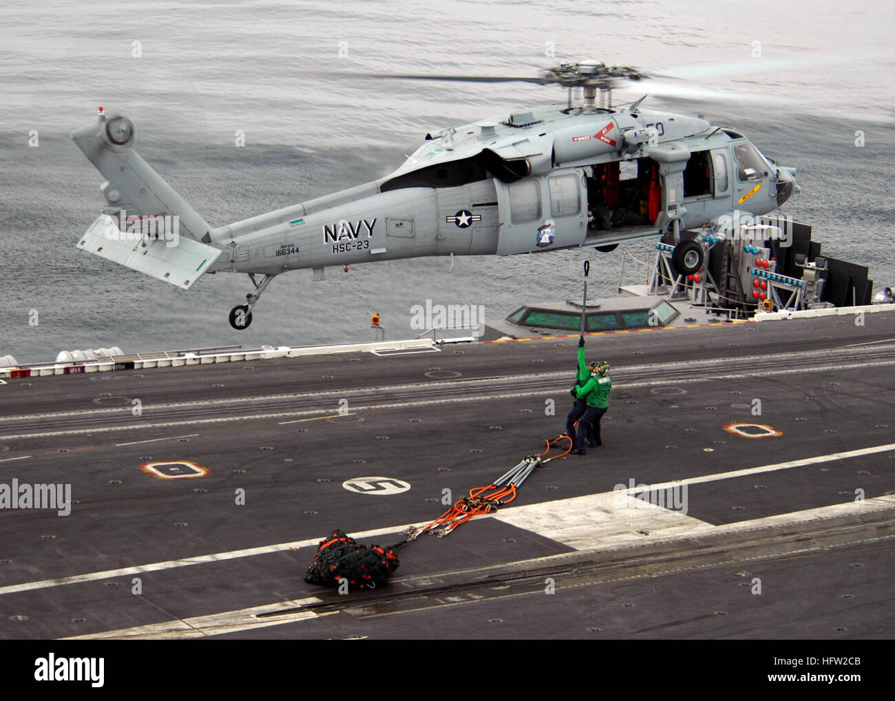 Sailors attach supplies mh 60s hi-res stock photography and images - Alamy