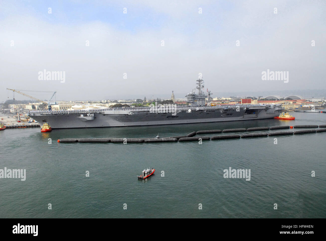 Sailors man the rails on the flight deck of nuclear-powered aircraft ...