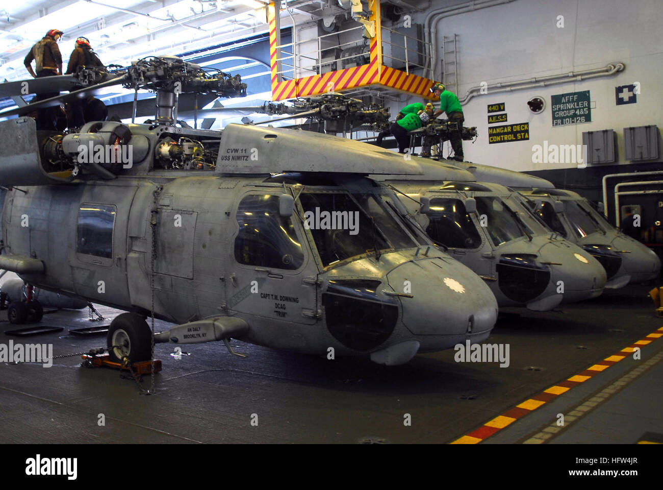 Sailors of HS-6 inspect rotor heads on an SH-60 Seahawk in USS Nimitz ...