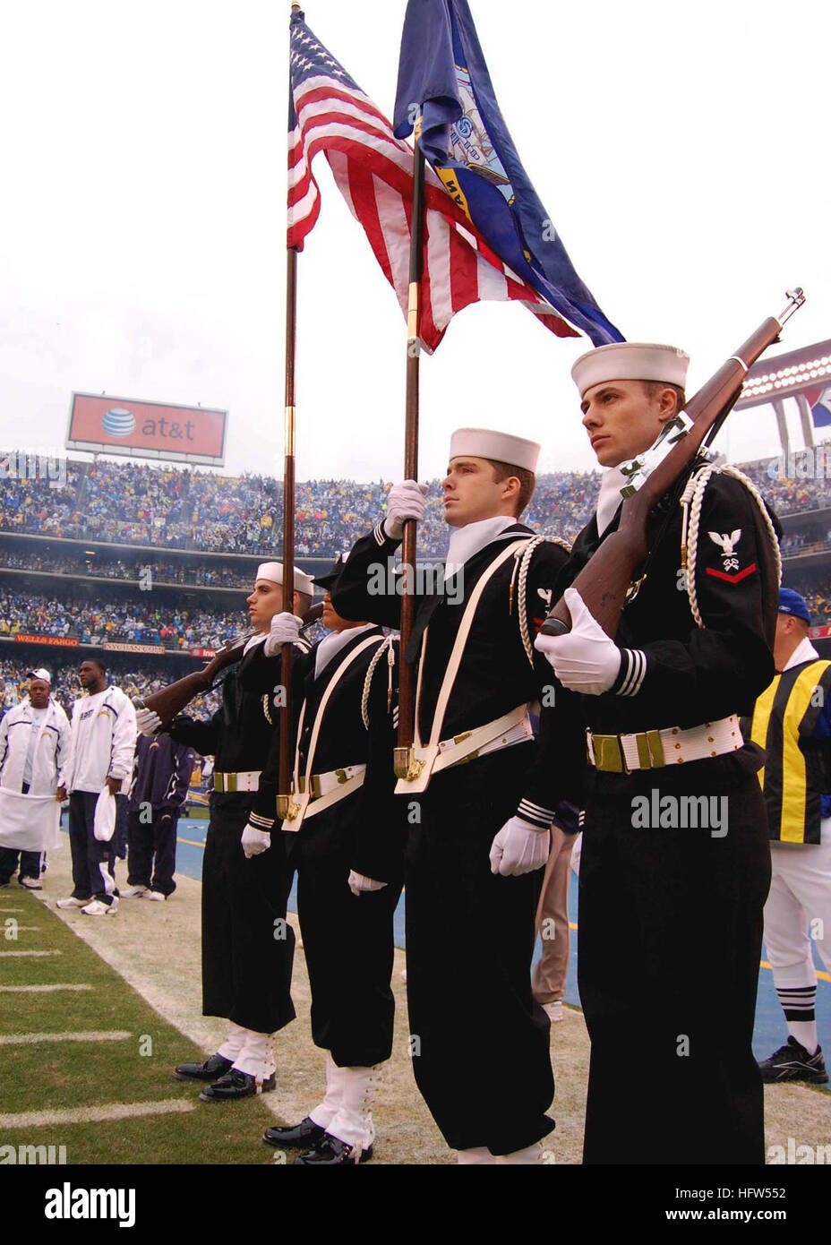 The color guard from USS Rushmore (LSD 47) presents the national colors ...