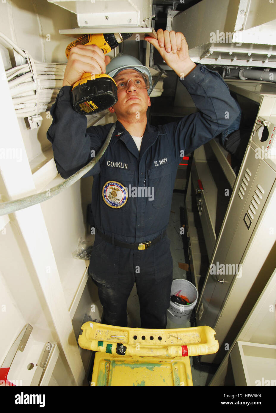 An Operations Specialist installs an air diffuser in a remodeled ...