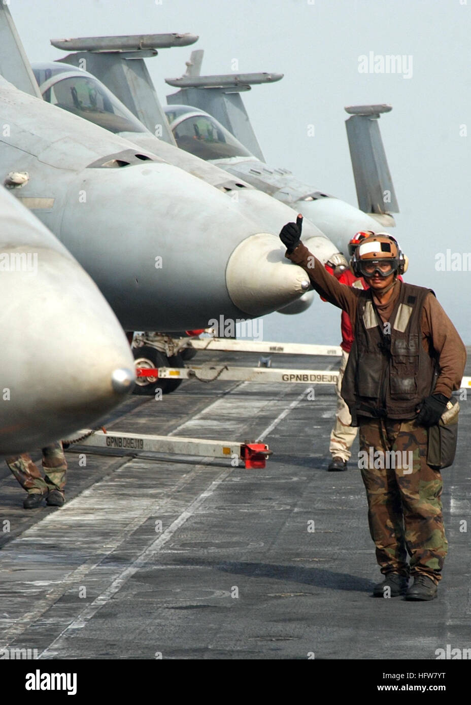 A Plane Captain signals the F/A-18 Hornet is ready for launch aboard ...