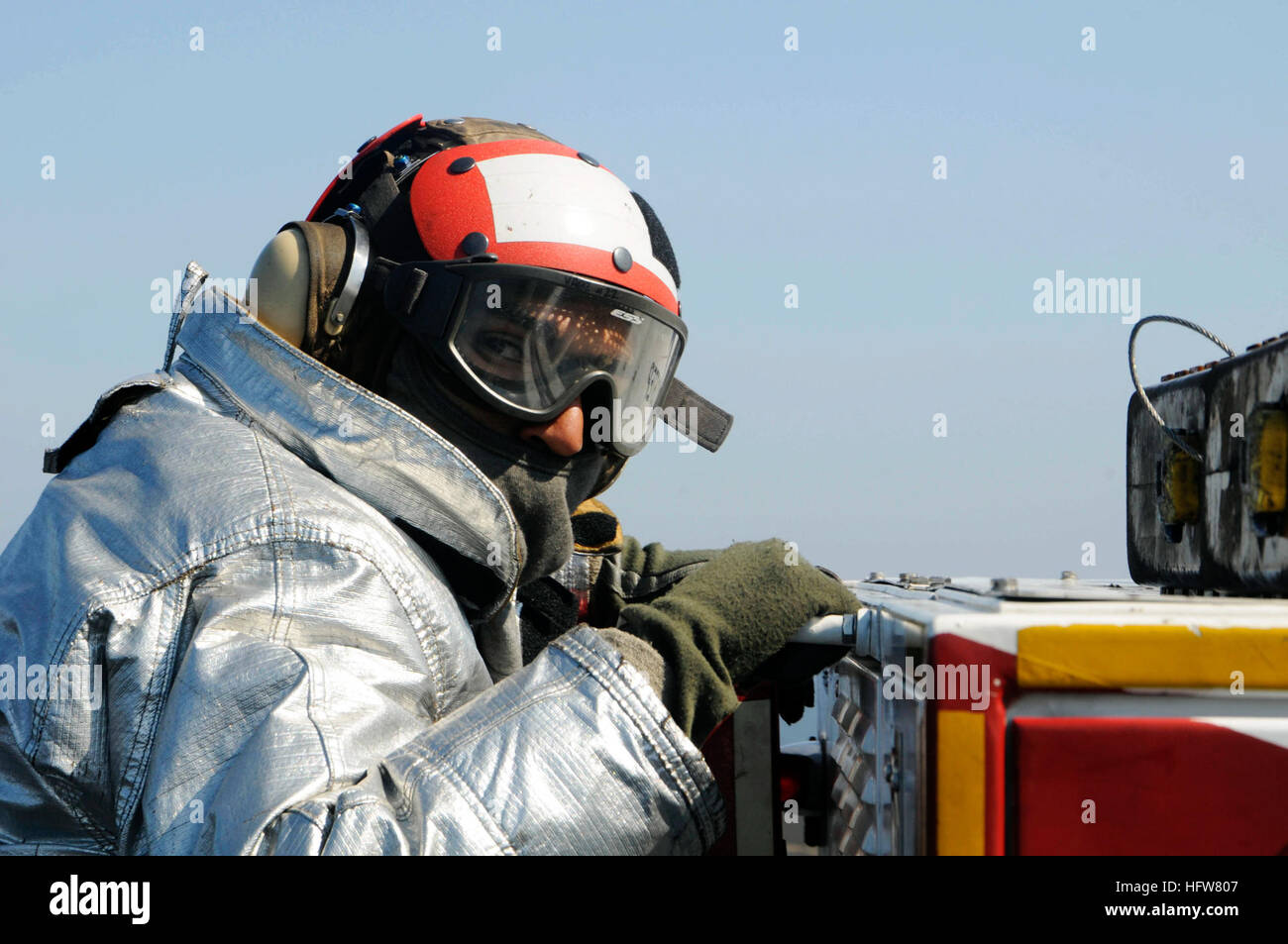 Aviation Boatswain's Mate stands fire watch on a P-25 flight deck fire ...