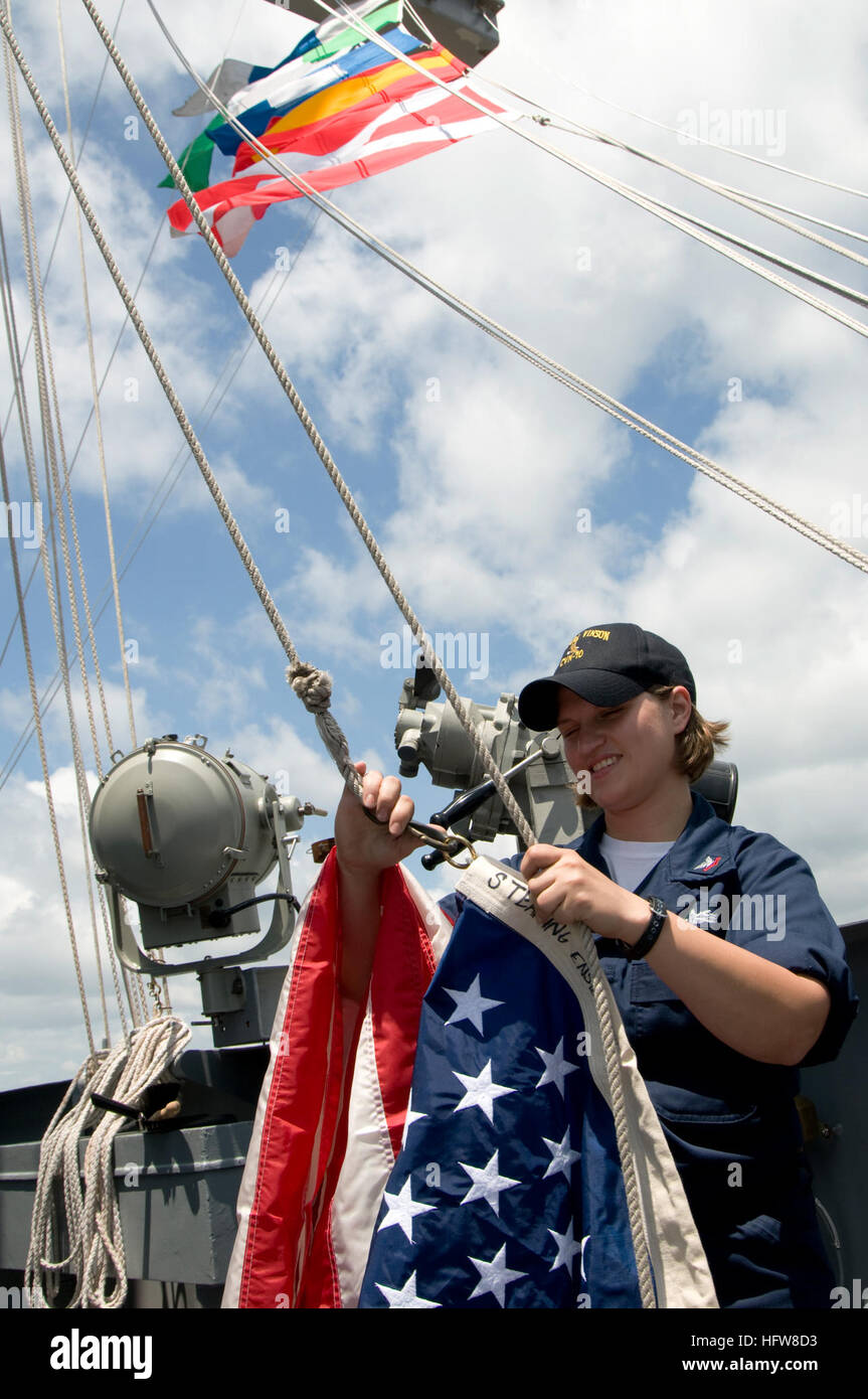Quartermaster 2nd Class attaches the national ensign aboard USS Carl ...