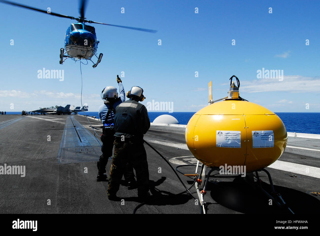 Sailors install a MK-53 Nulka Decoy Launching System on the flight deck ...