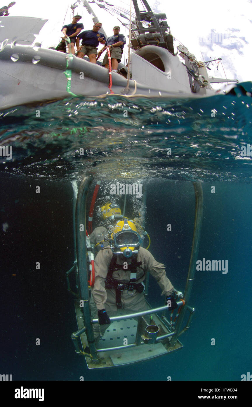 A diver rides a stage to the sea bed from MSC rescue and salvage ship ...