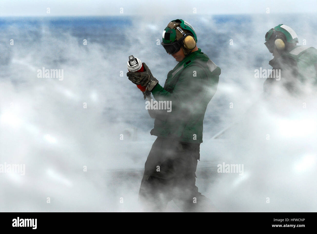 Aviation Boatswain's Mate (Equipment) 3rd Class removes the hold back ...