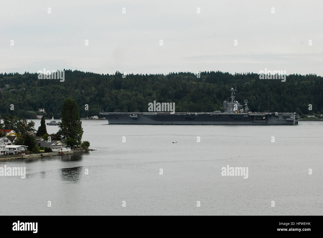 The aircraft carrier USS John C. Stennis (CVN 74) passes the Manette ...