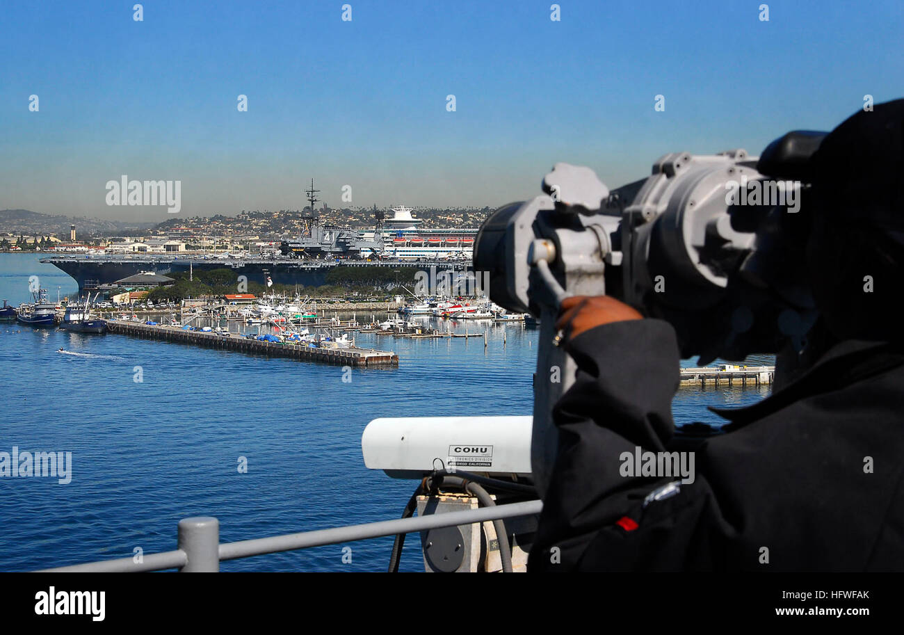 A Sailor aboard the amphibious assault ship USS Boxer observes the ...