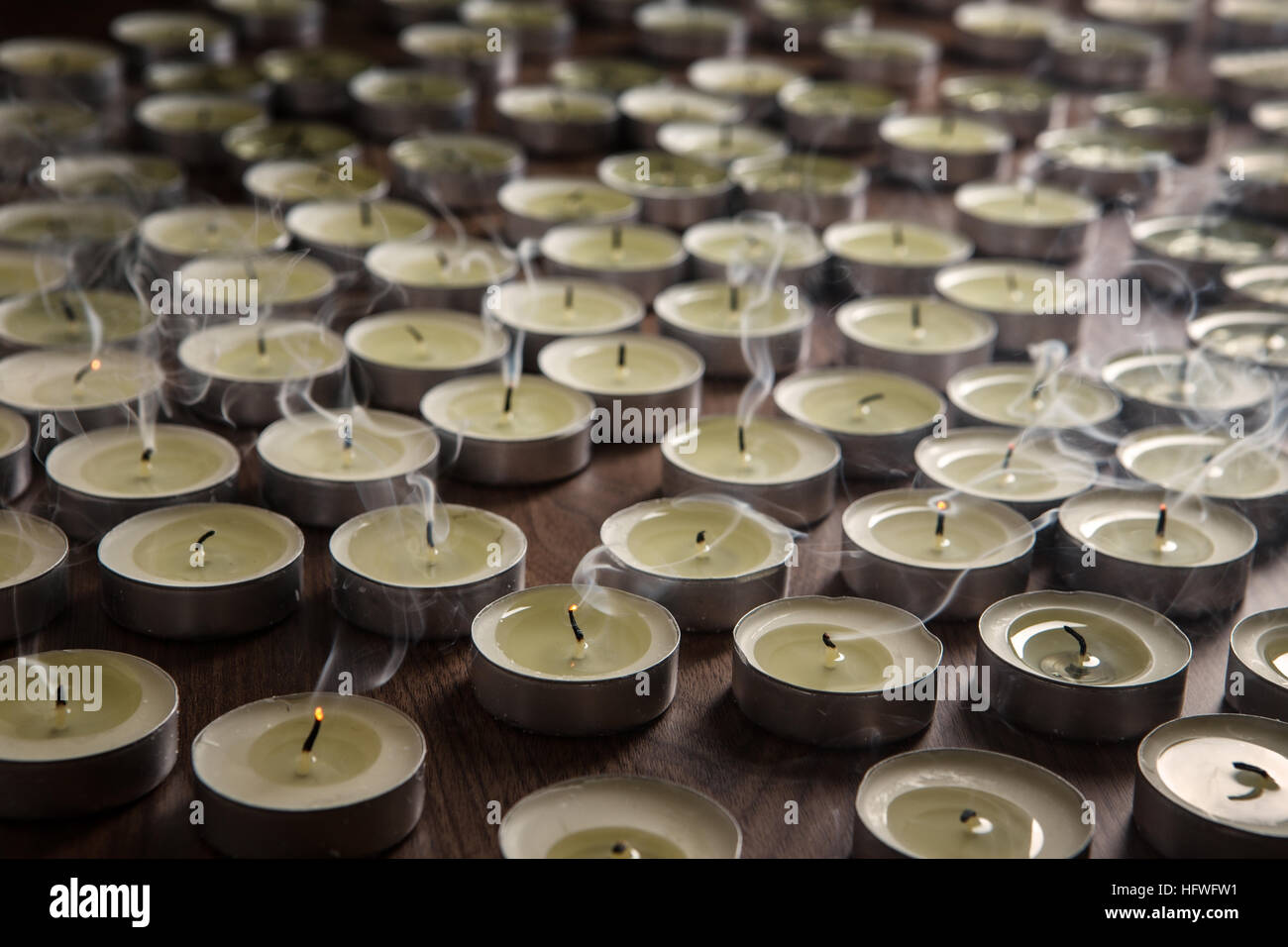 many tea candles lit on table Stock Photo - Alamy
