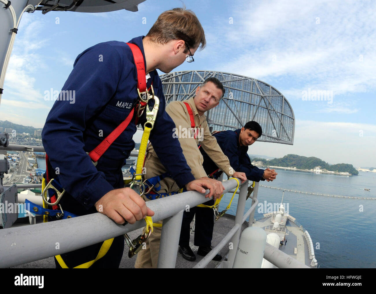 Crew aboard the amphibious command ship USS Blue Ridge perform ...