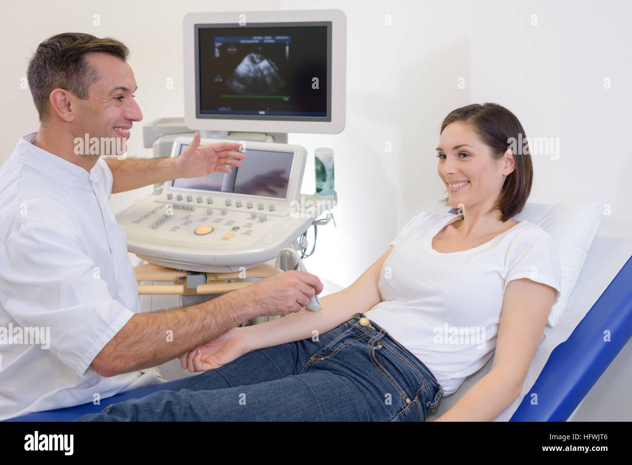 Medic scanning woman's arm Stock Photo - Alamy