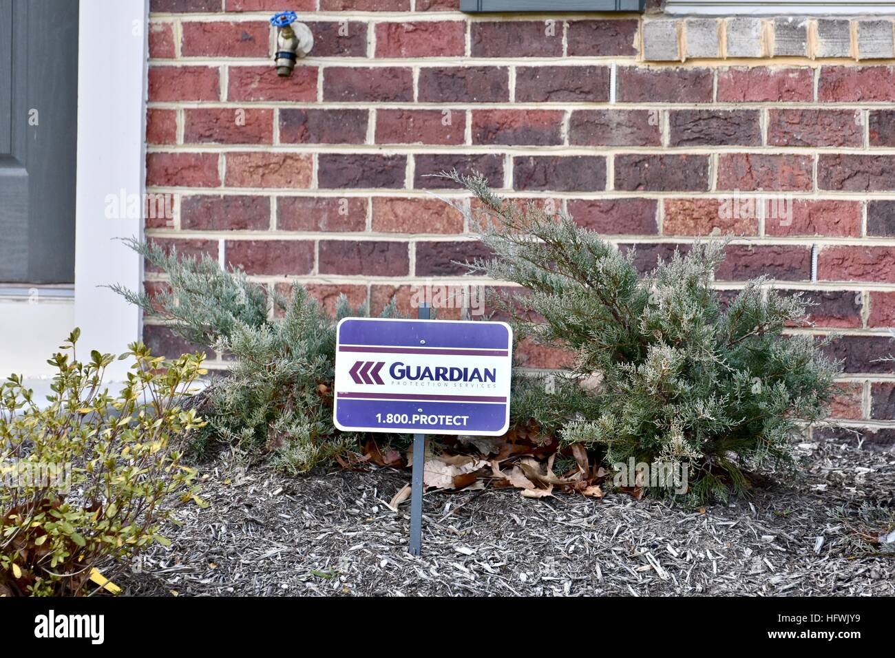 A Guardian protection sign displayed in the front of a residential home ...