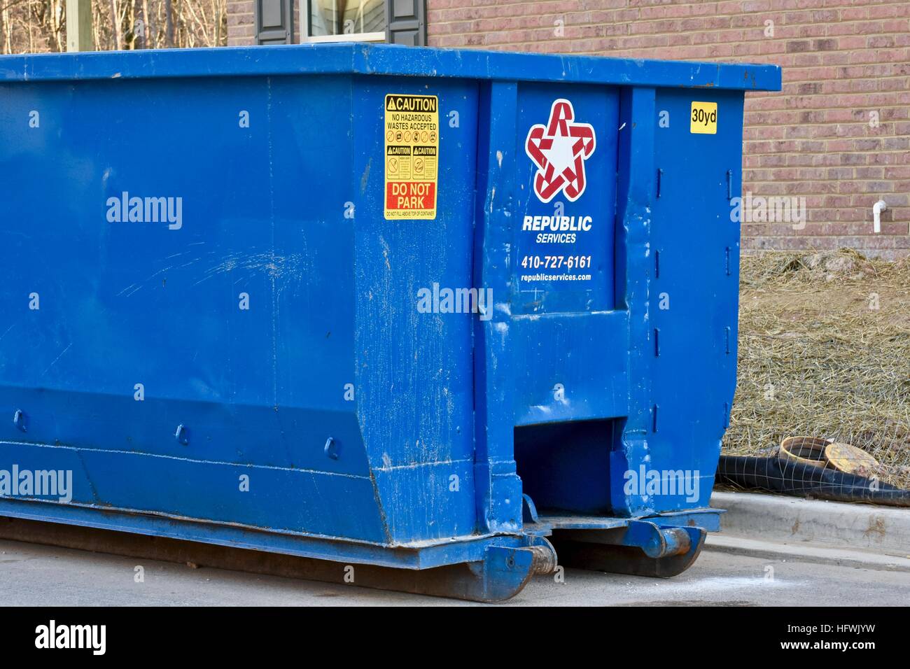 A blue construction dumpster on the street Stock Photo - Alamy