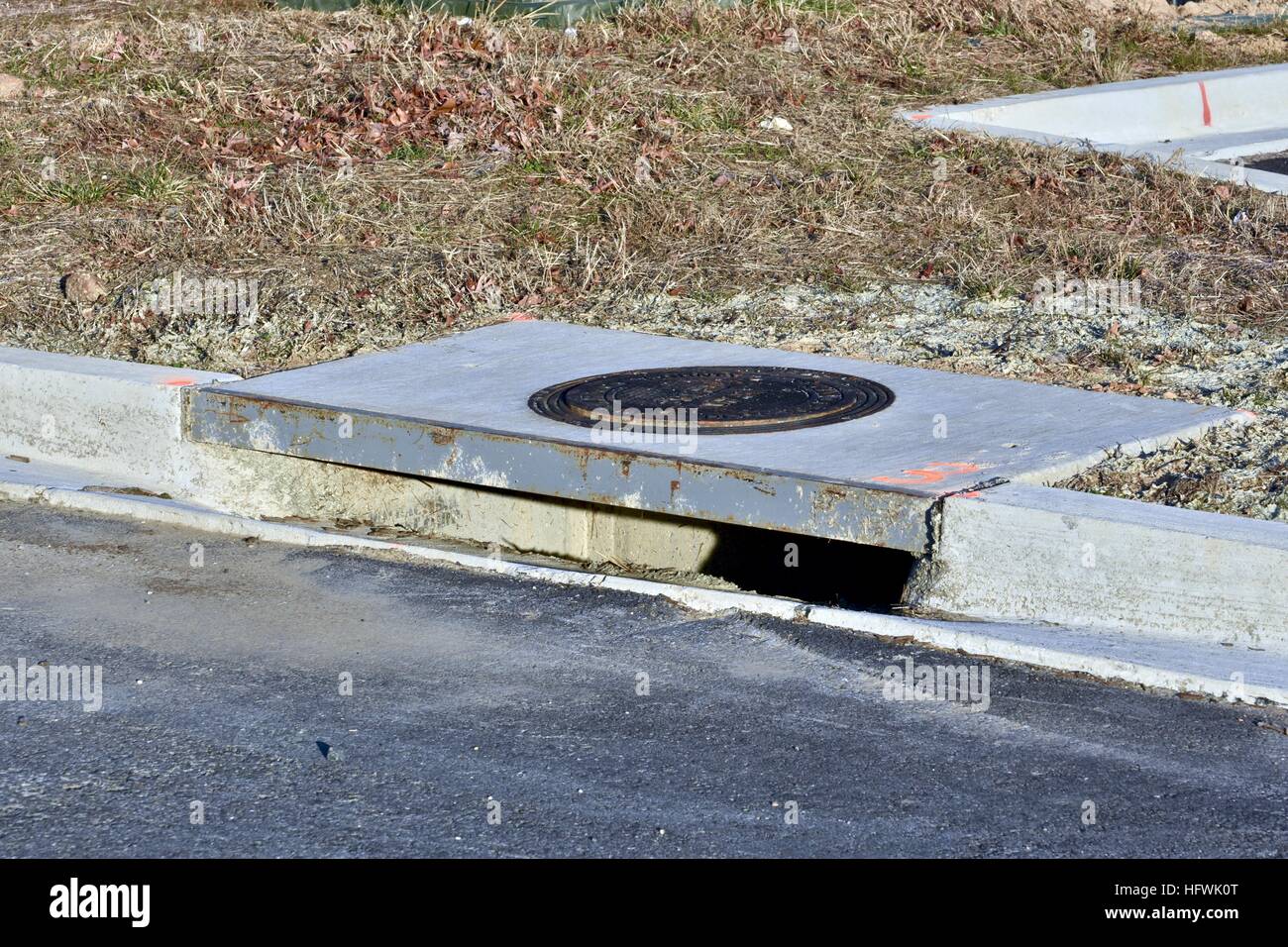 A covered manhole with an exposed opening for the storm drain Stock ...