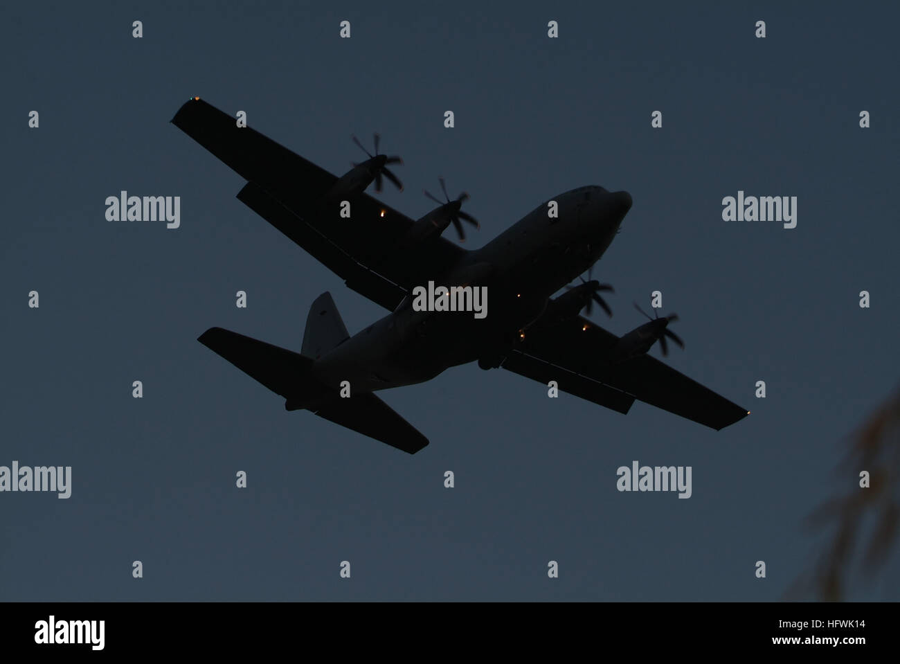 A Hercules military aircraft flying at low altitude at night Stock ...