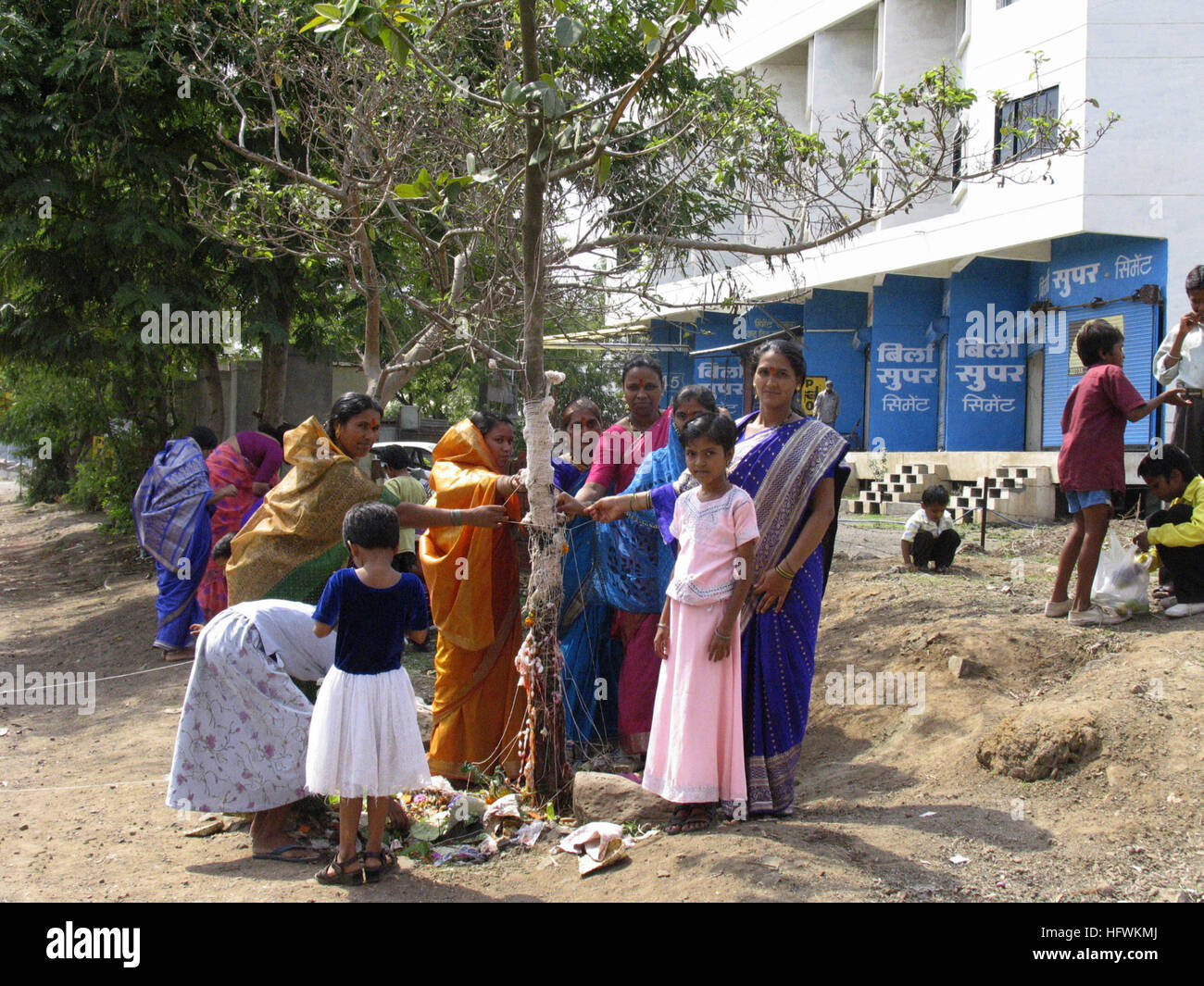 Indian Festival - Vat Savitri: woman tying thread around banyan tree ...