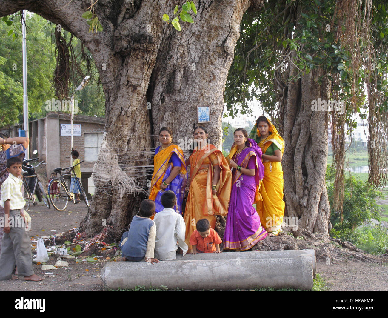 Indian Festival - Vat Savitri: woman tying thread around banyan tree ...