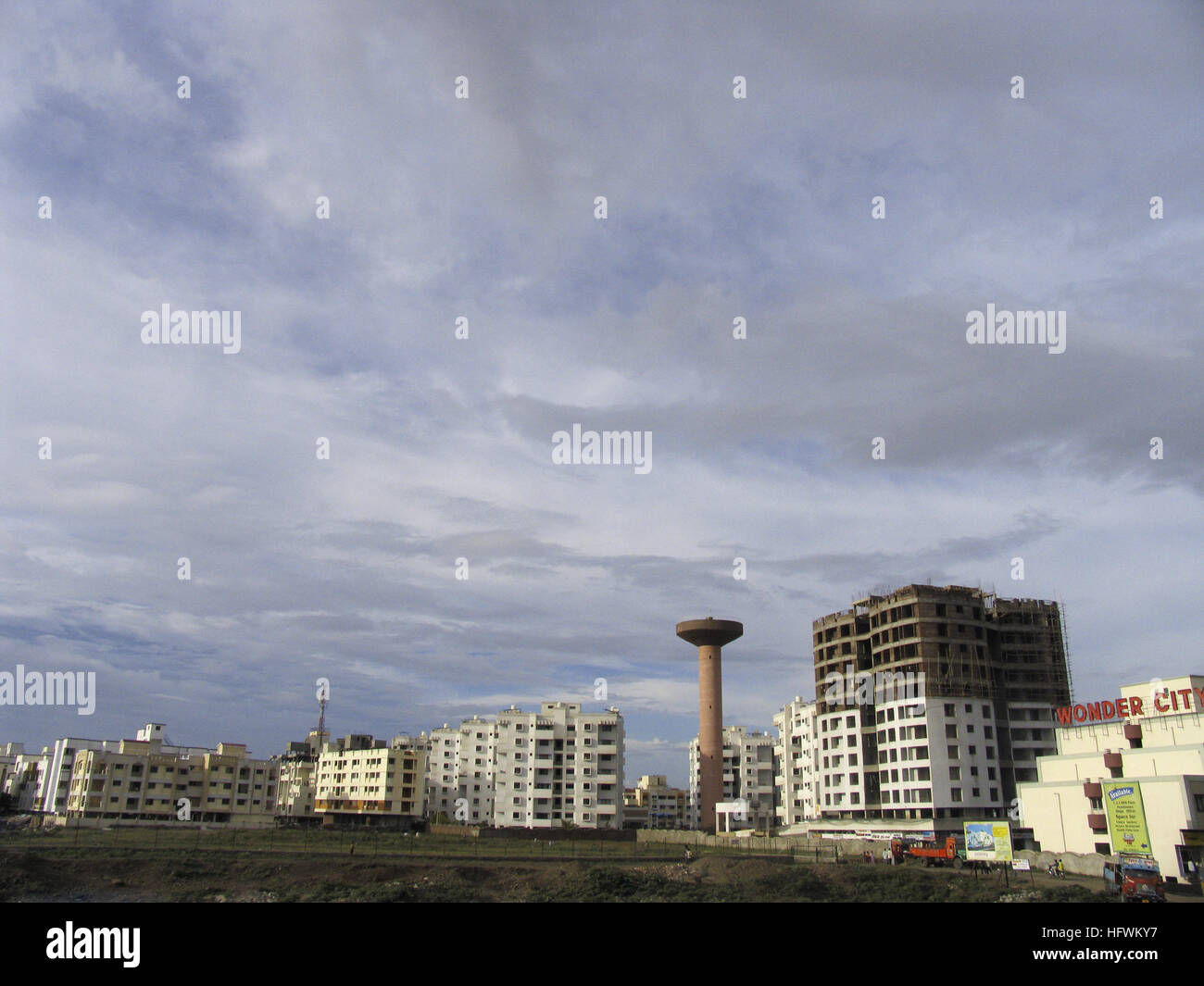 City landscape with building and cloudy sky Stock Photo - Alamy