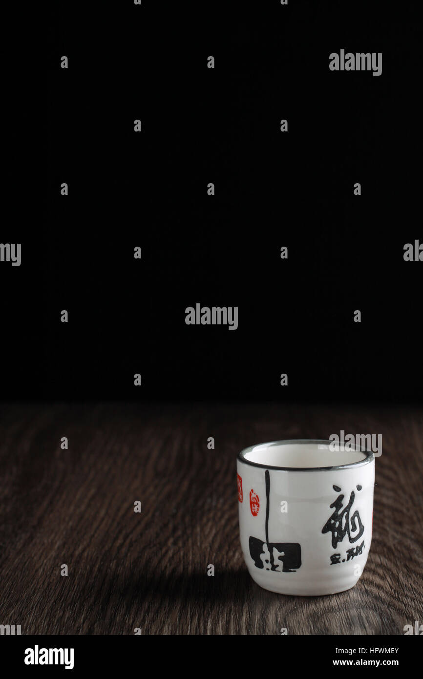 japan sake ceramic bottle and cup with black background shoot in the ...