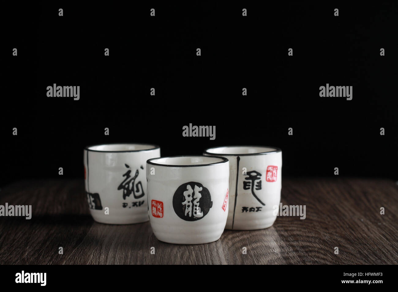 japan sake ceramic bottle and cup with black background shoot in the ...