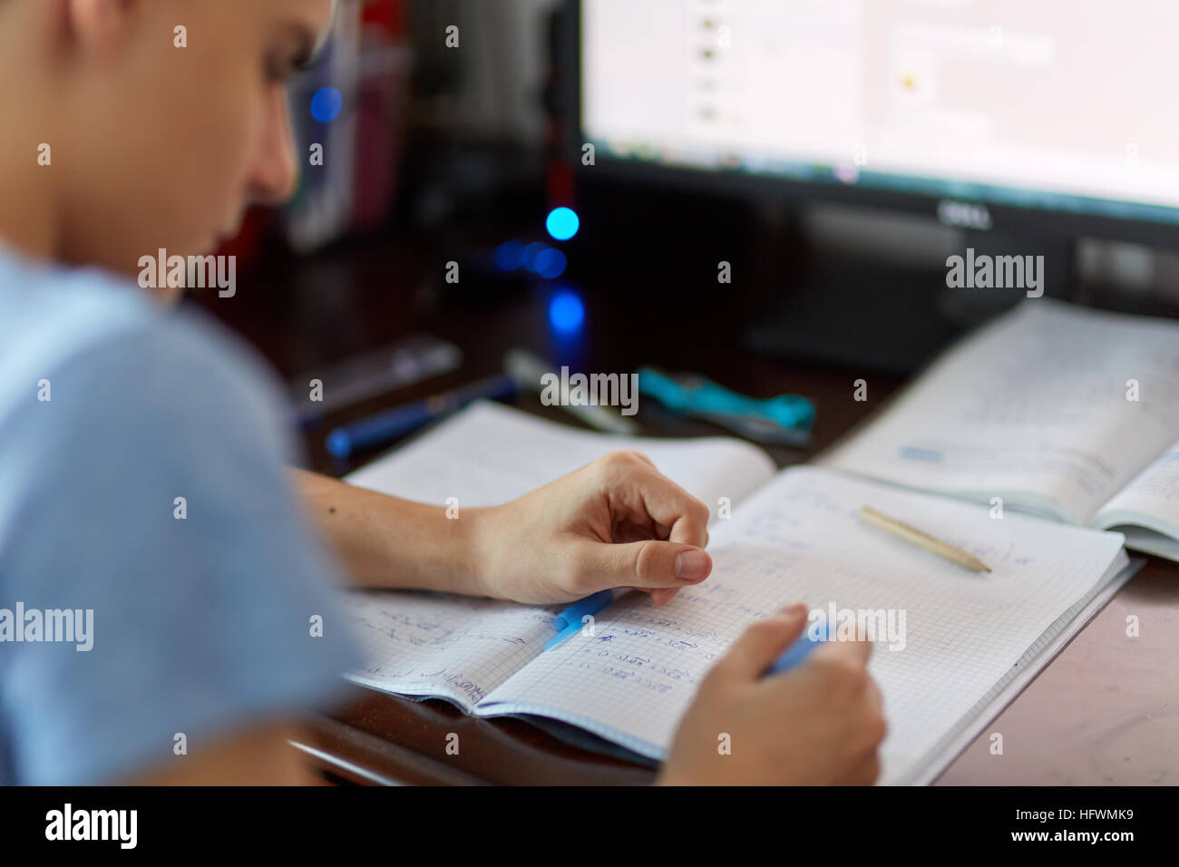 Teenager boy doing homework on his desk at home Stock Photo - Alamy