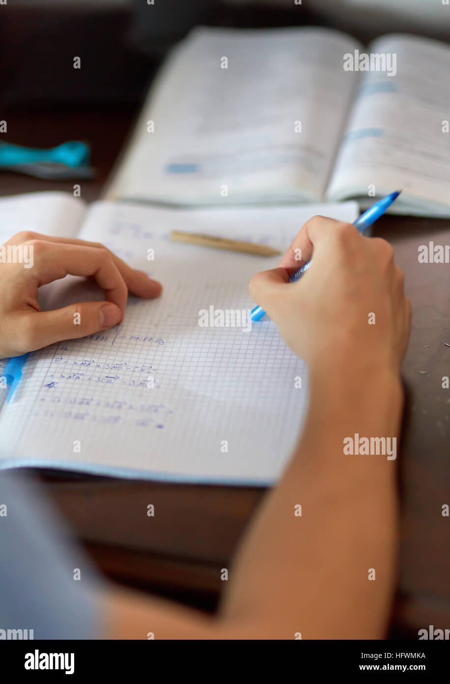 Teenager boy doing homework on his desk at home Stock Photo - Alamy