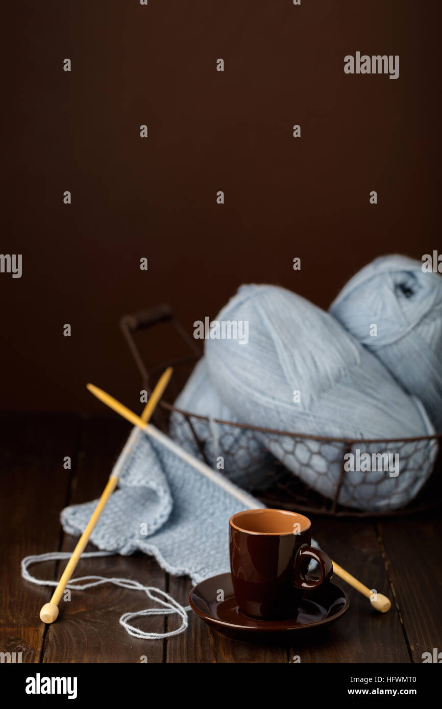 Knitting from light blue yarn and a cup of coffee Stock Photo - Alamy