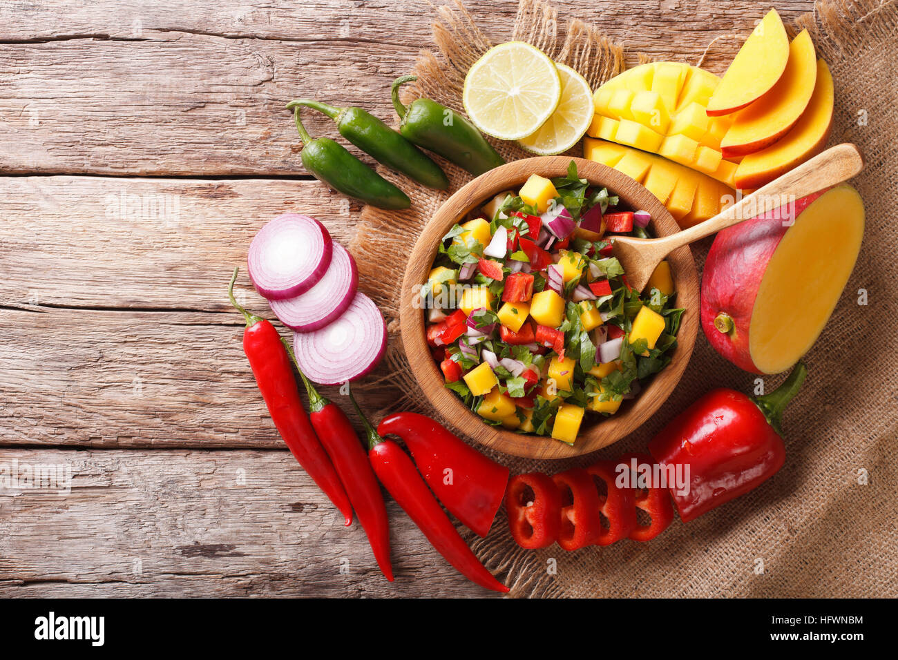 Mexican salsa with mango, cilantro, onions and hot peppers close up in ...