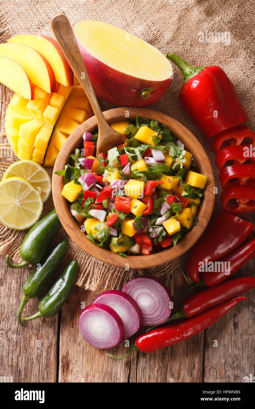 Salsa with mango, cilantro, onions and peppers close up in a bowl and ...