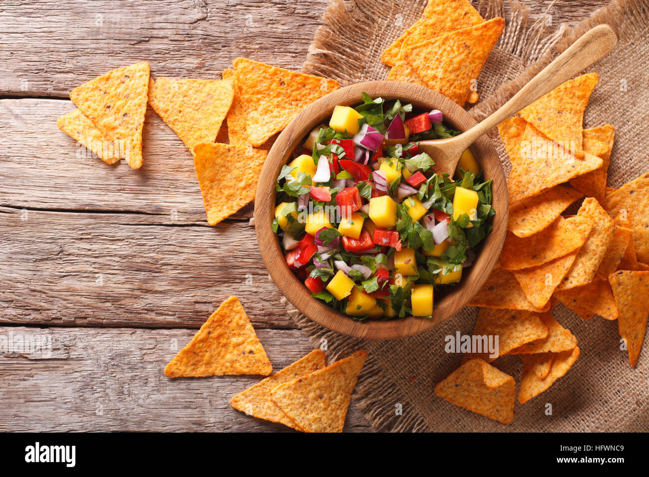 Delicious salsa with mango, chilli pepper, cilantro and onion close up ...