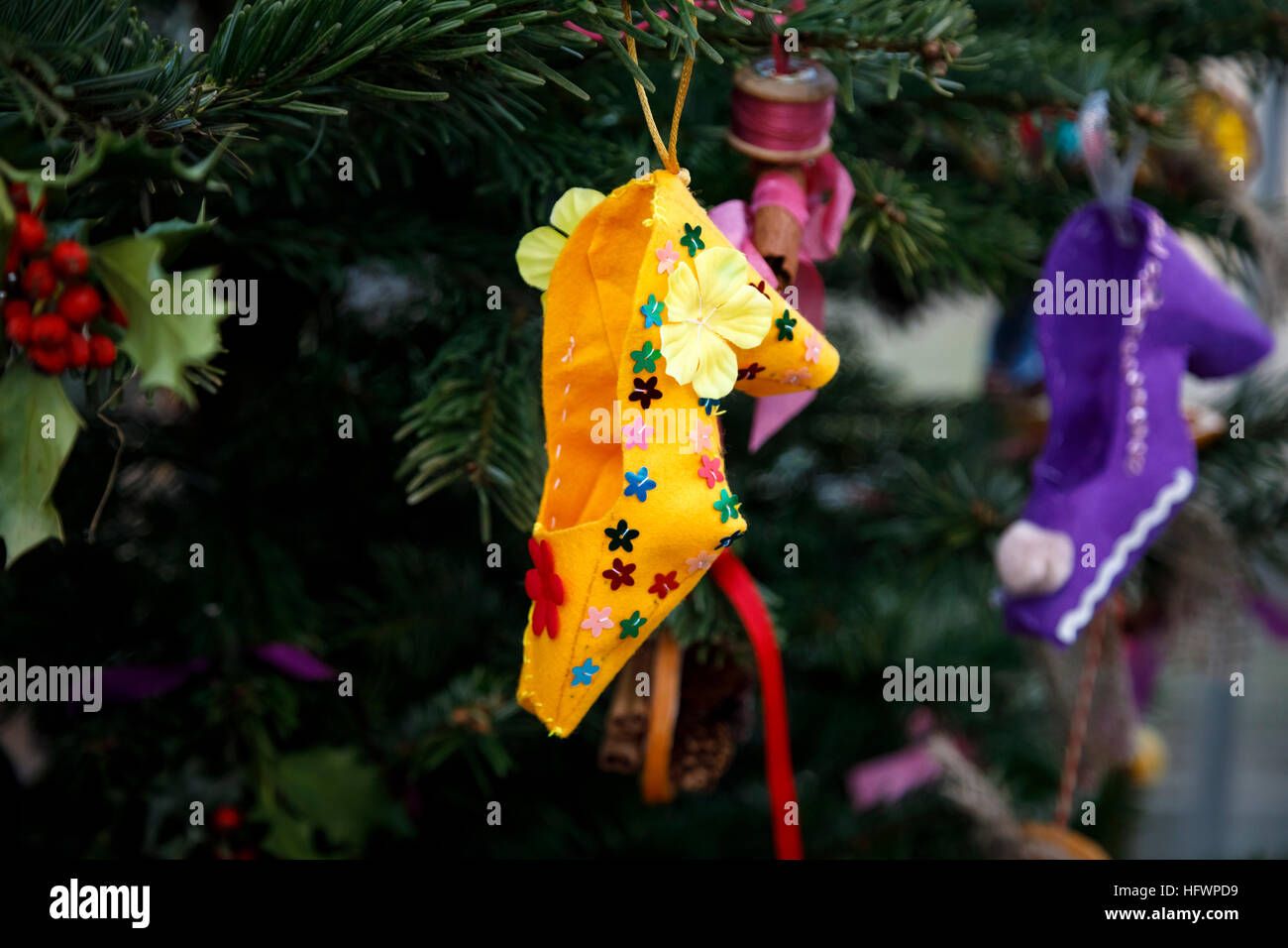 Yellow and purple home made shoe decorations hanging on a Christmas ...