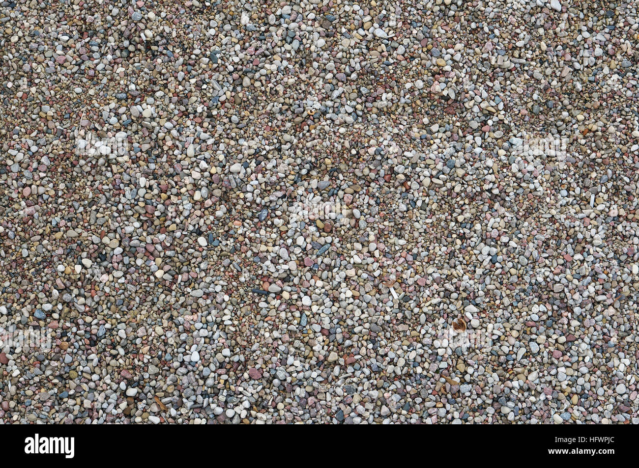 Small wet round granite gravel is used for a water filtration. Top view ...