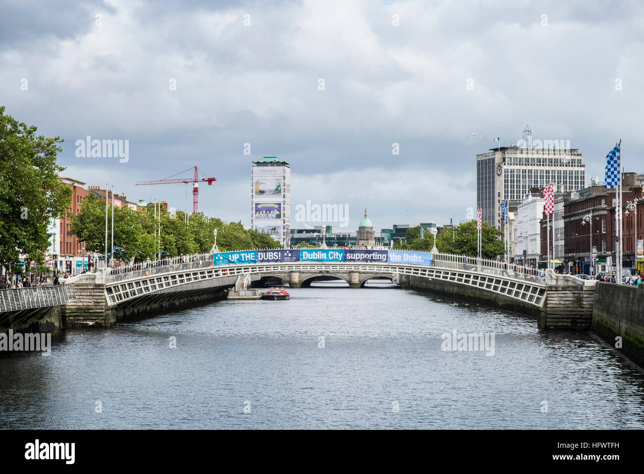 Looking east along the river Liffey, halfpenny bridge with banners ...