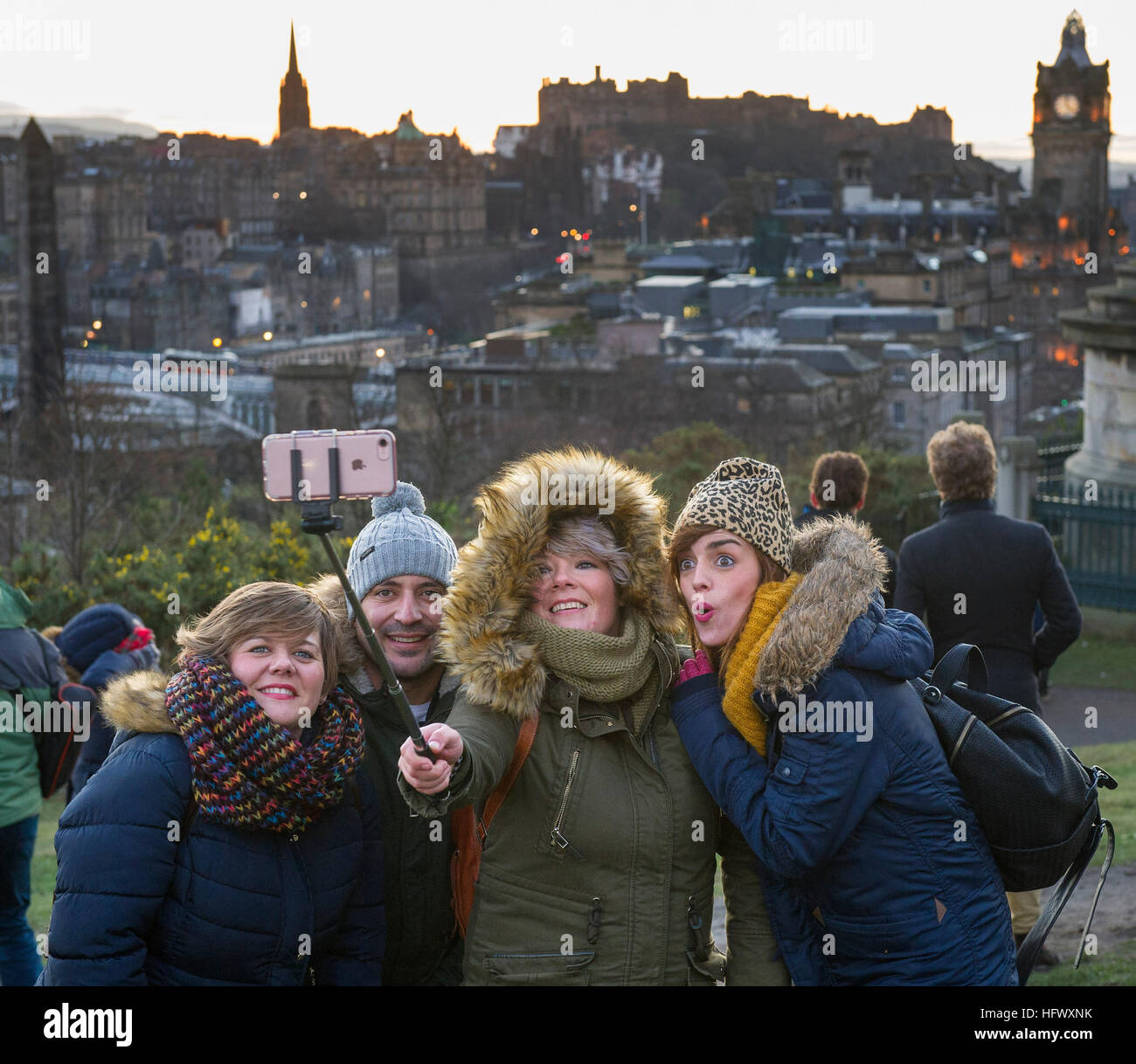 Tourists take a selfie on Calton hill with the Edinburgh skyline and ...