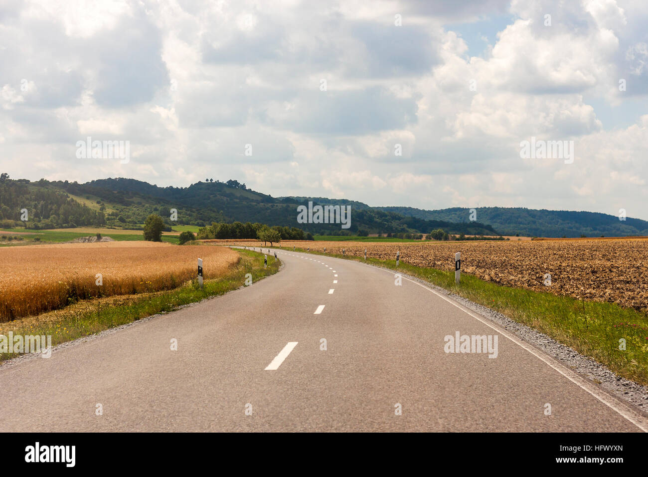 Asphalt country rural road in Germany through the green field and ...