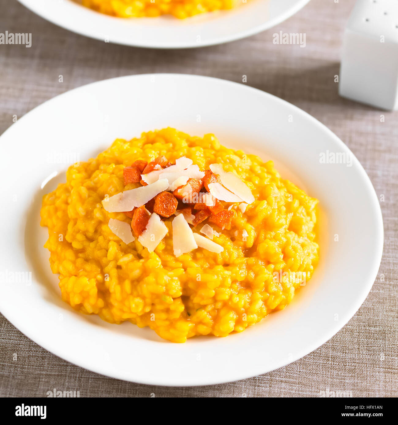 Fresh homemade carrot risotto made with pureed carrot, garnished with ...