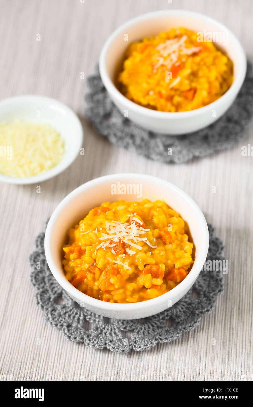 Fresh homemade carrot risotto made with pureed carrot and roasted carrot pieces, garnished with ...