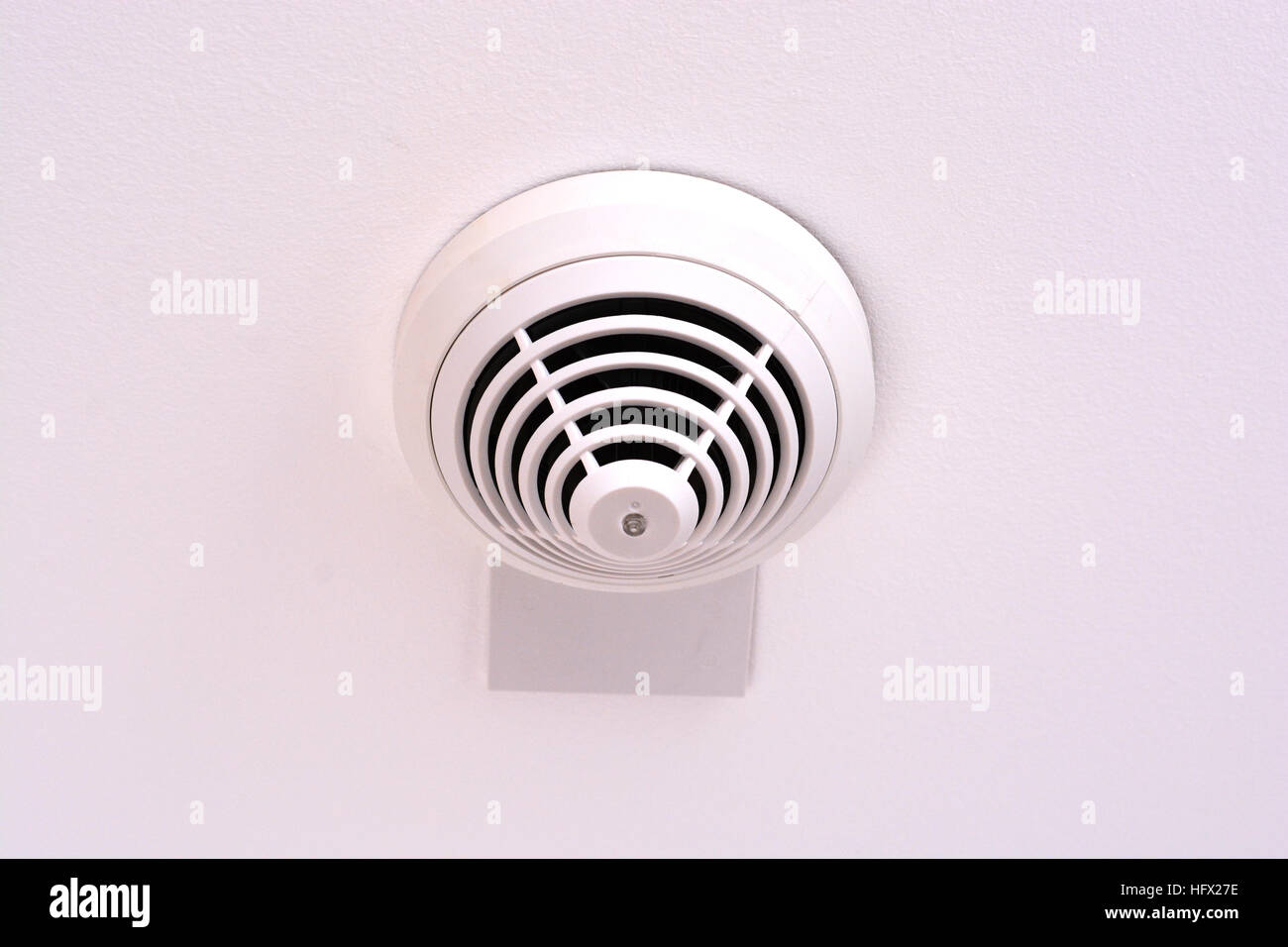 Modern smoke sensor installed on ceiling Stock Photo - Alamy