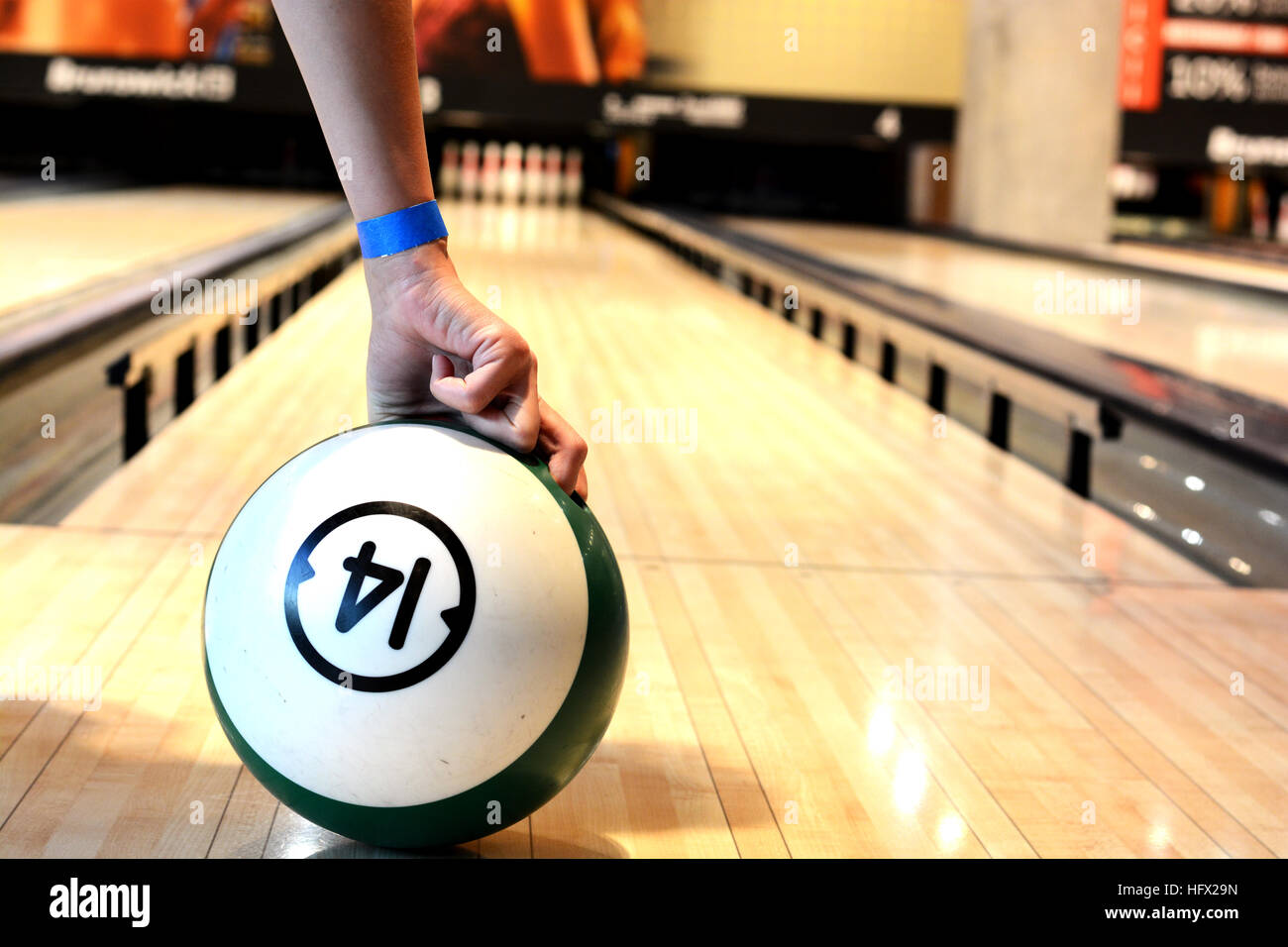 Woman hand holding a bowling ball in hand on bawling alley Stock Photo ...