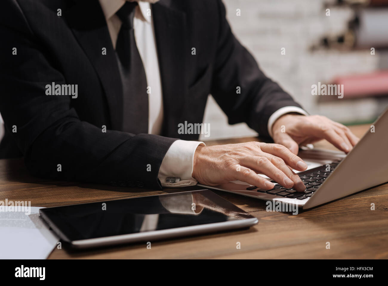 Stylish businessman typing on a laptop Stock Photo - Alamy