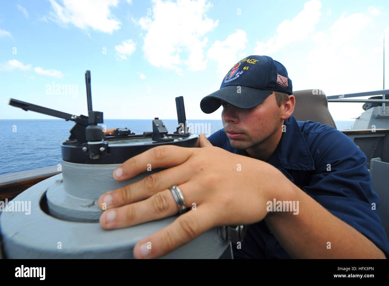 U.S. Navy Seaman Shawn Pritchard uses an azimuth to take a navigational ...