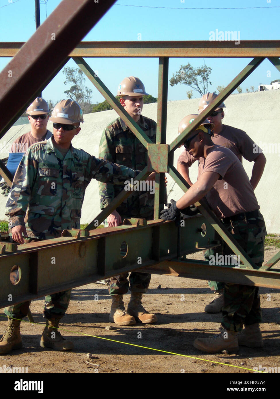 Builder directs a team to place the transom onto a Bailey Bridge panel ...