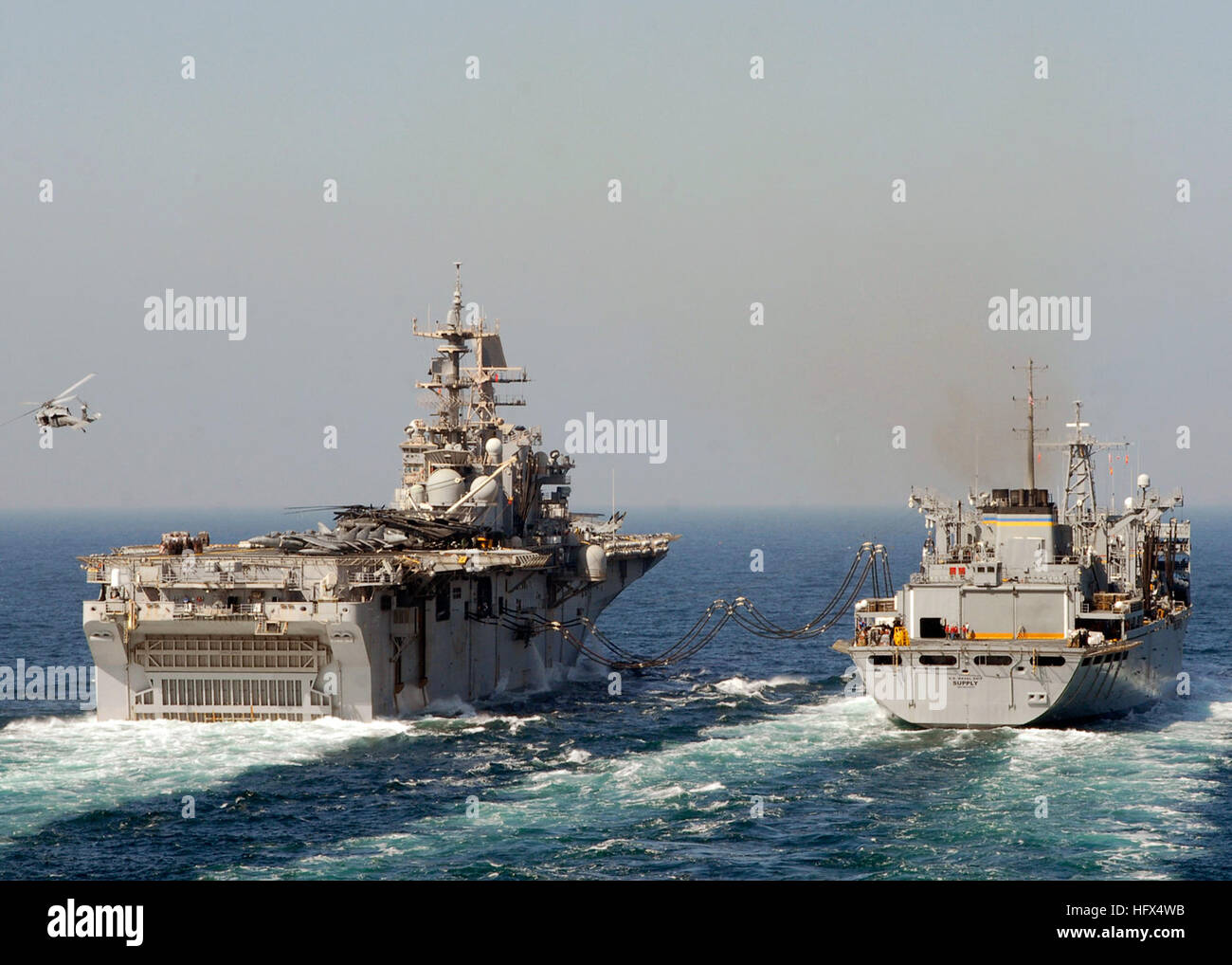 The multi-purpose amphibious assault ship USS Iwo Jima conducts a replenishment at sea with the ...