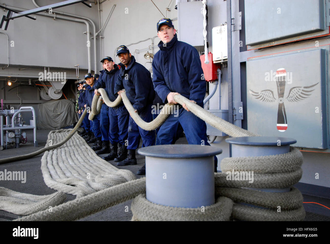 Sailors handle mooring lines on the fantail of Nimitz-class aircraft ...
