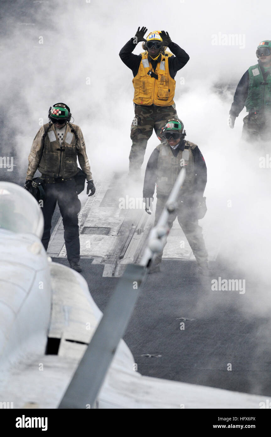 Airman Daryl Cobb uses hand signals to tell the pilot of an F/A-18C ...