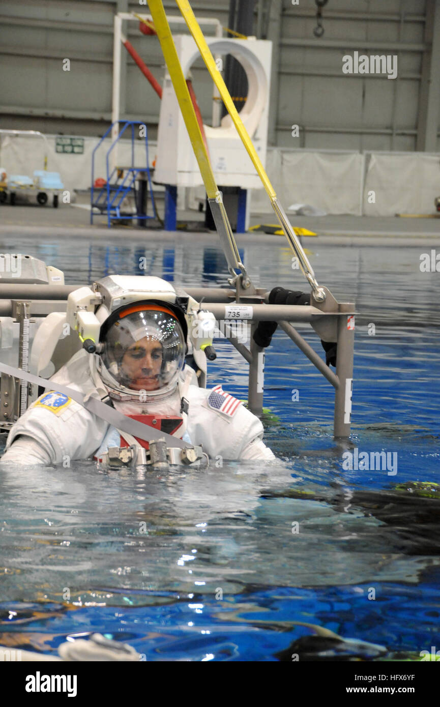 A U.S. Navy SEAL is lowered into the Neutral Buoyancy Laboratory in ...