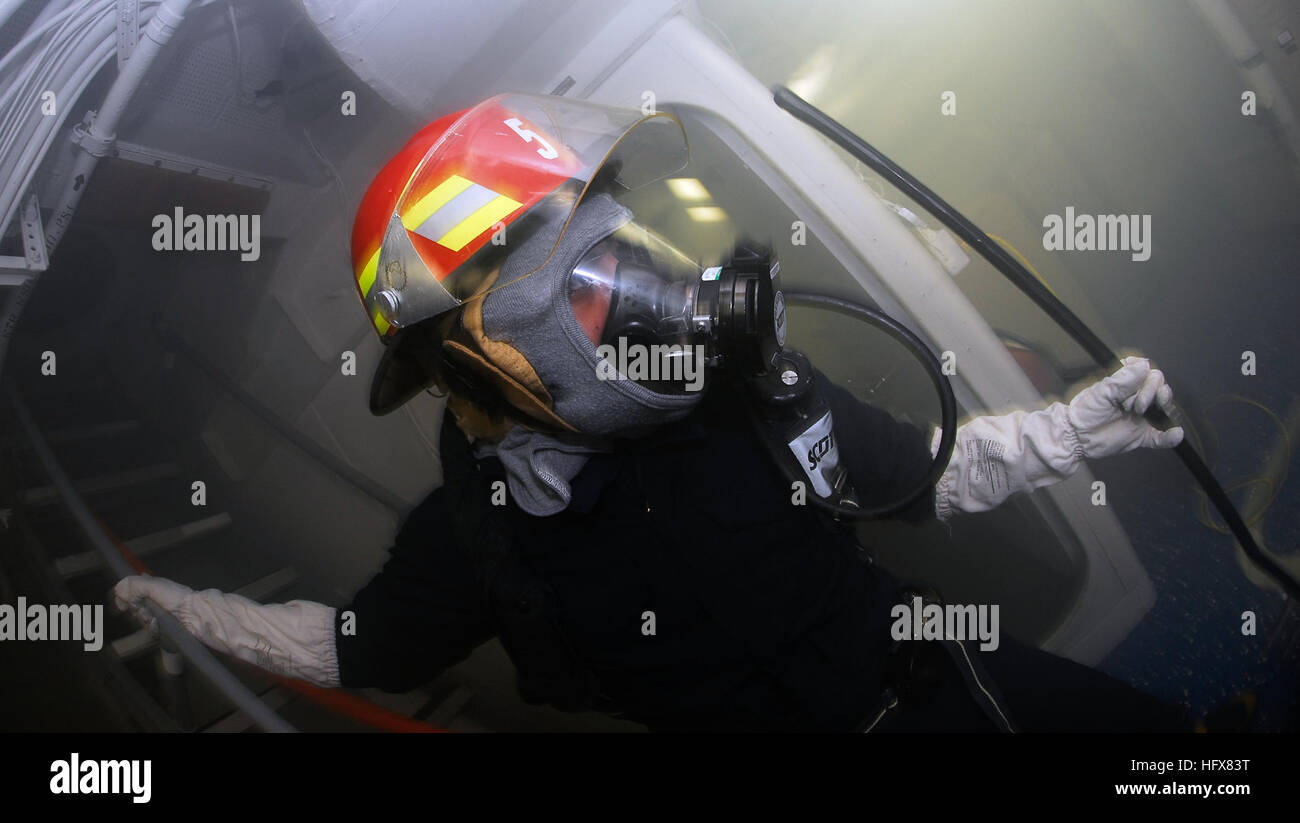 A Seaman Apprentice overhauls a simulated class alpha fire aboard the ...