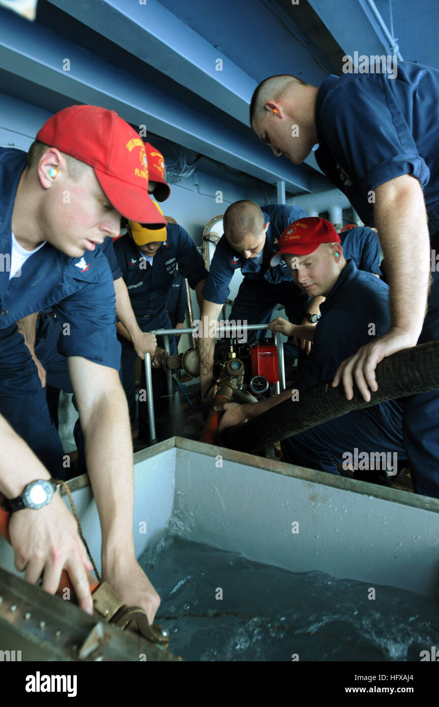 Petty Officer 3rd Class (SW) Brett Malen, damage controlman, sprays ...