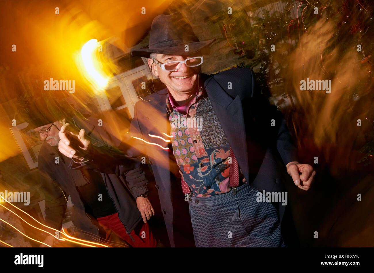 Middle aged man dancing at party dressed in braces and having fun Stock ...